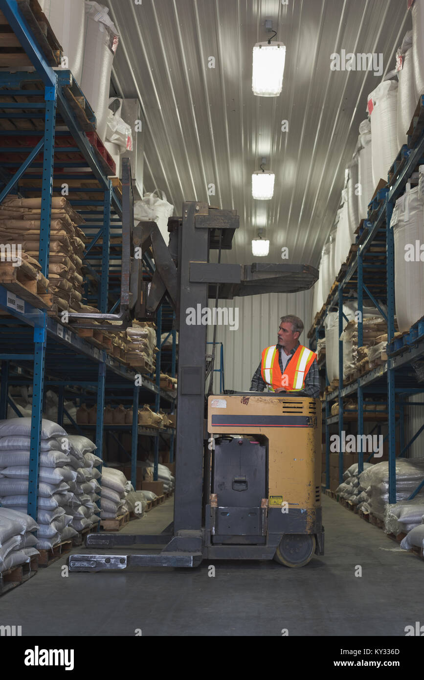 Man lifting sack of grains with forklift Stock Photo - Alamy
