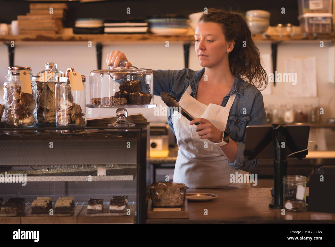 Beautiful waitress working at counter Stock Photo - Alamy