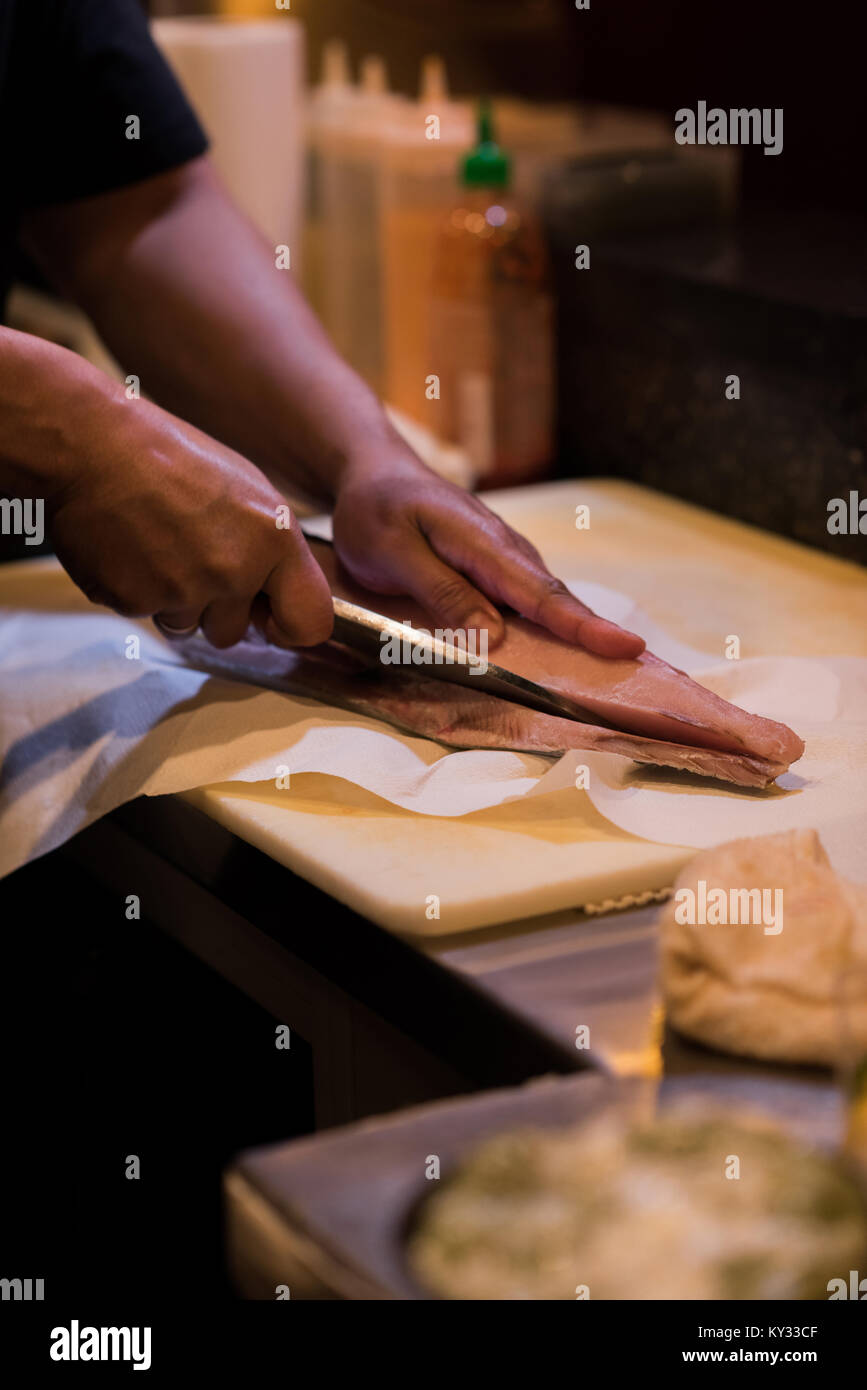 Chef filleting fish in the restaurant kitchen Stock Photo - Alamy