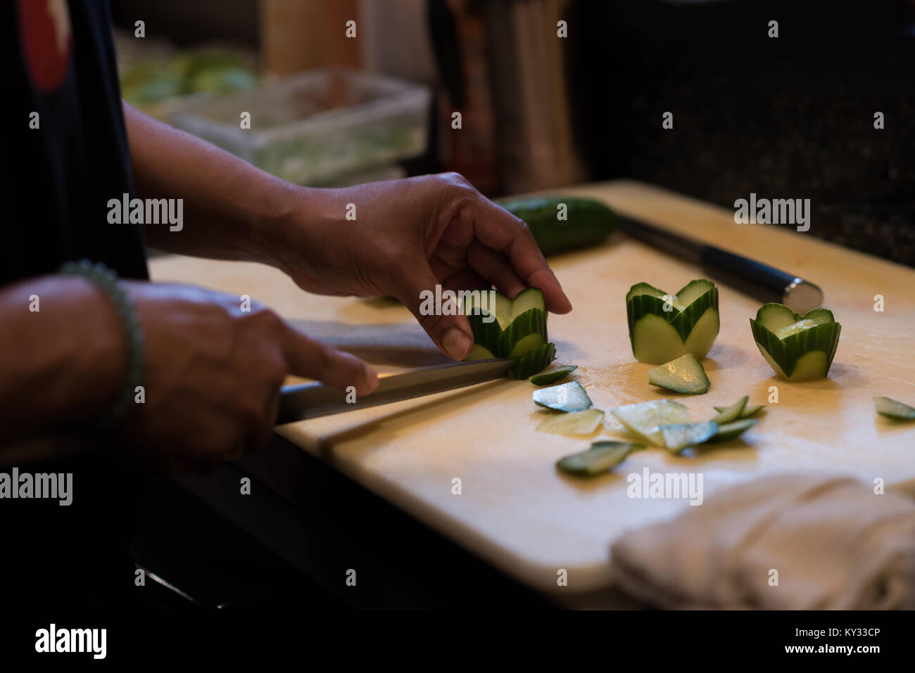 Chef slicking cucumber with a deba knife Stock Photo - Alamy