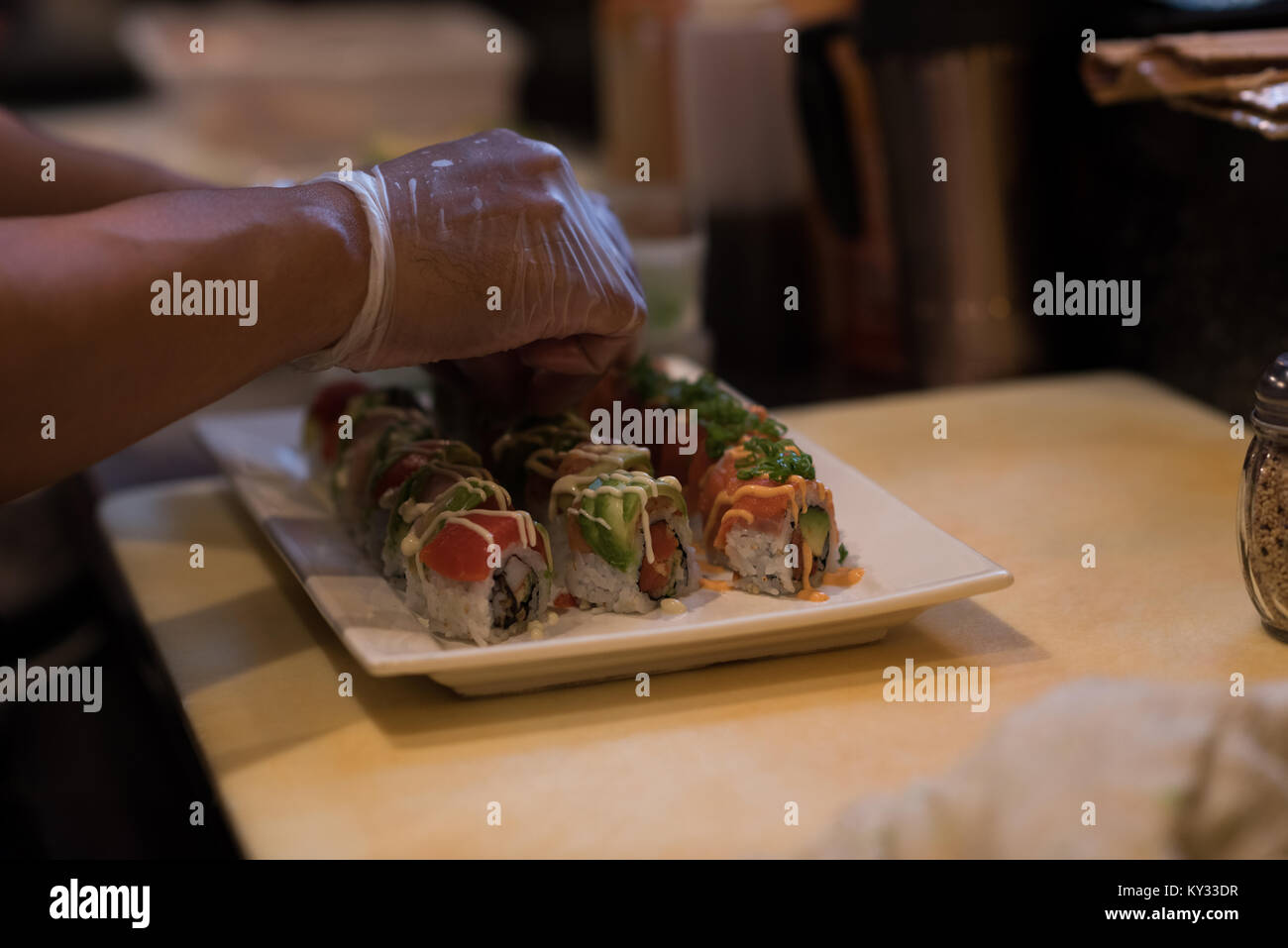 Chef garnishing sliced sushi Stock Photo - Alamy