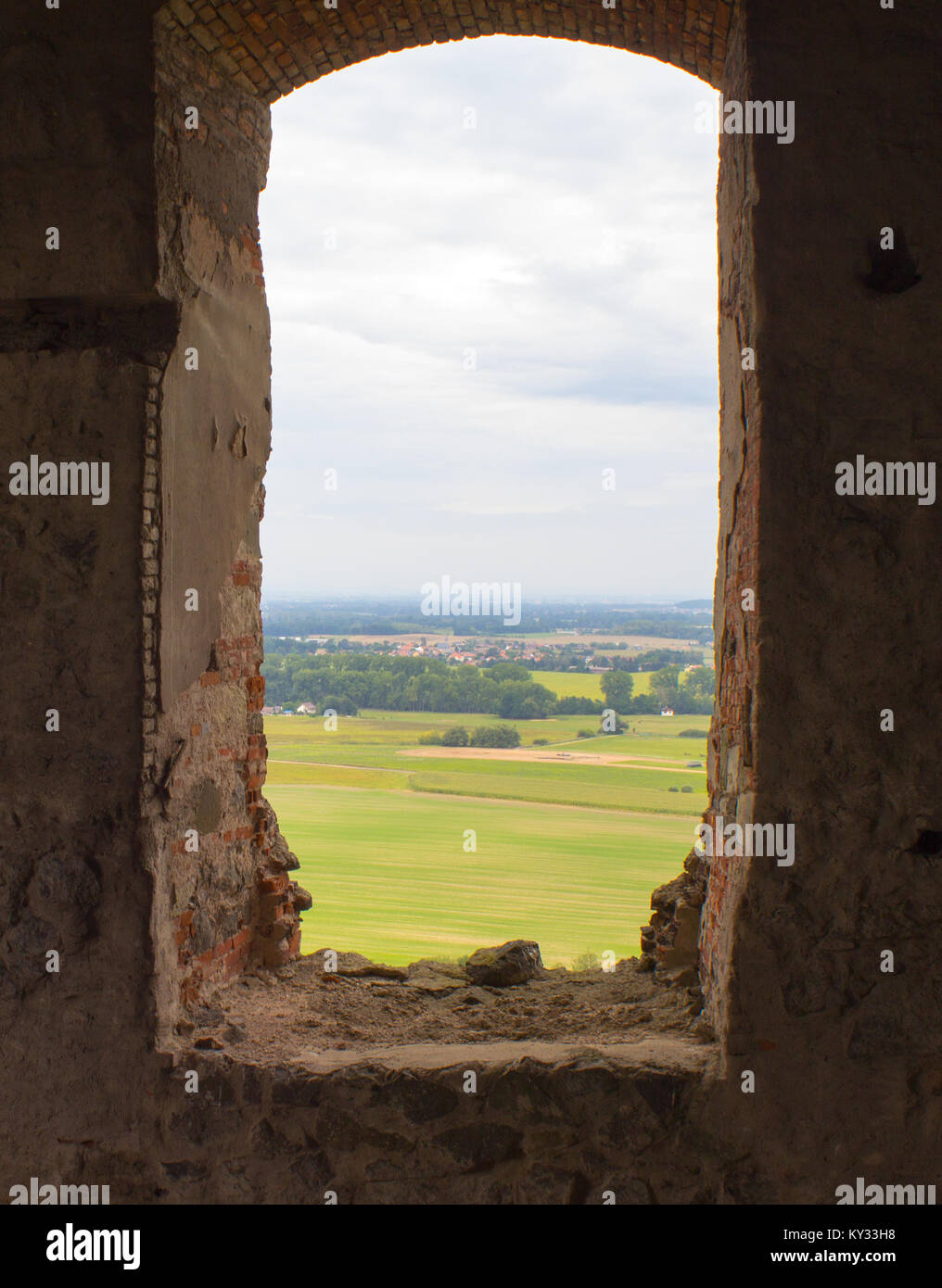 A view through a window in the brick wall into the landscape Stock ...