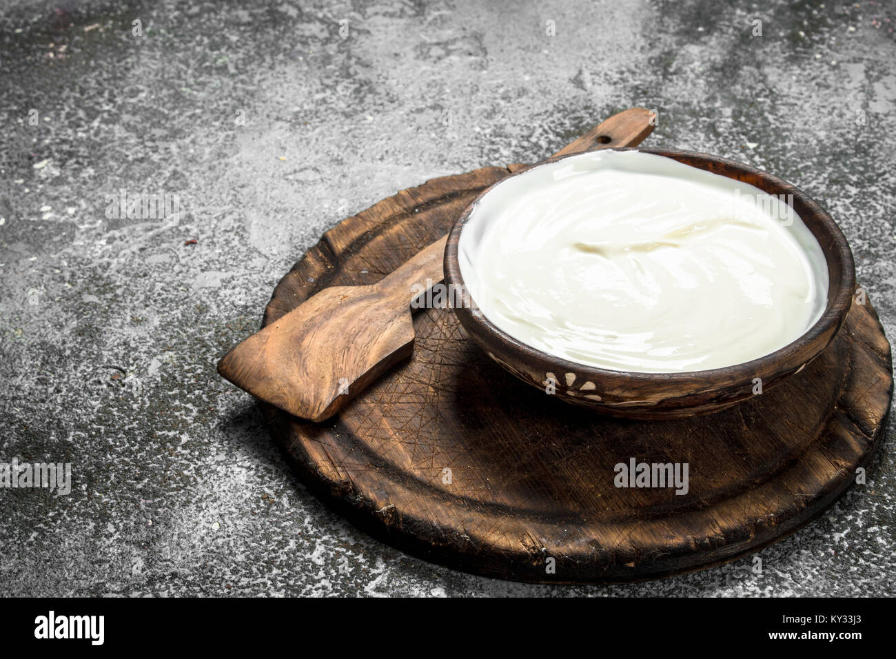 Natural yogurt in a bowl. On a rustic background Stock Photo - Alamy