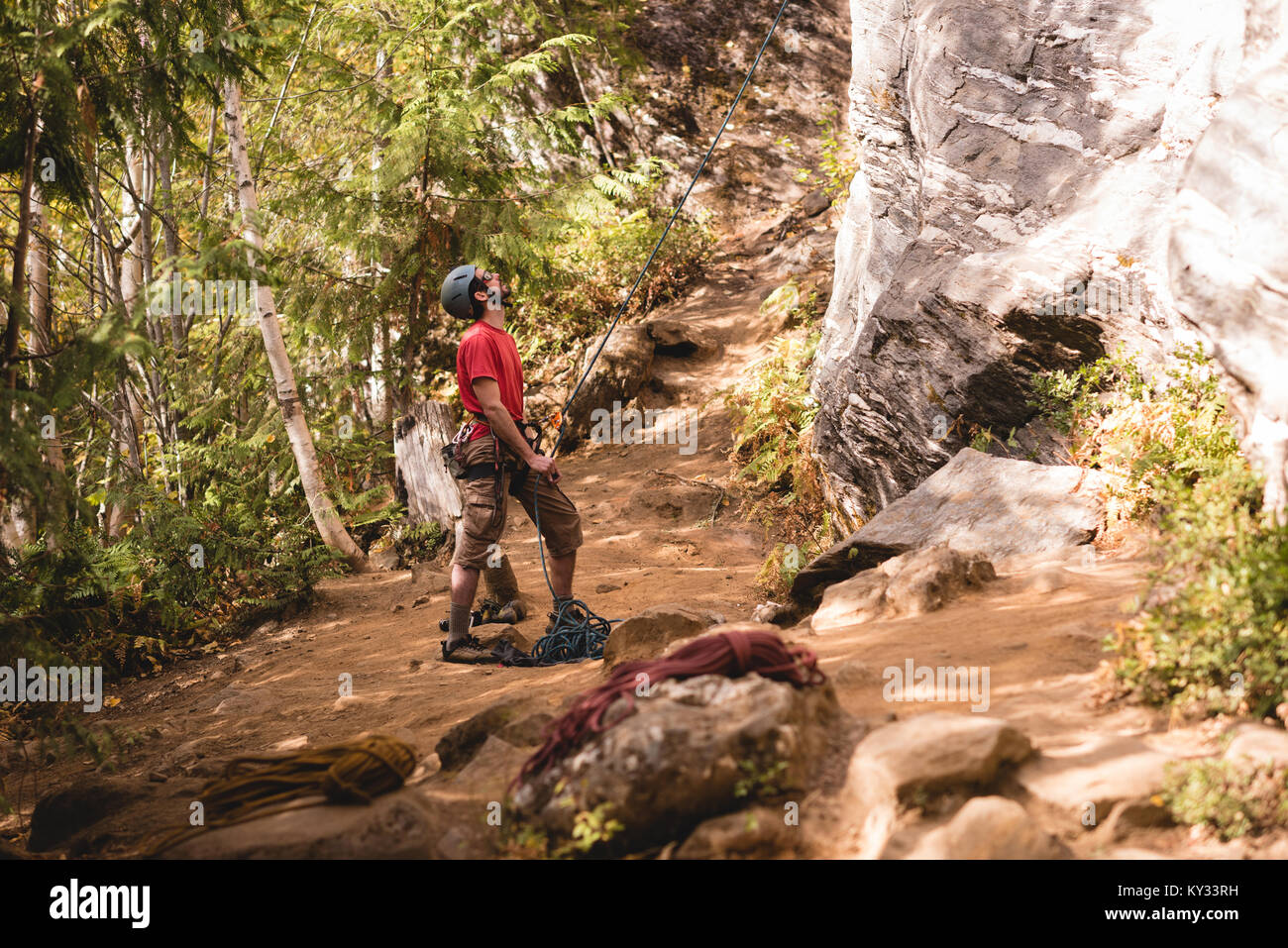 Hiker preparing himself to climb the rocky mountain Stock Photo - Alamy