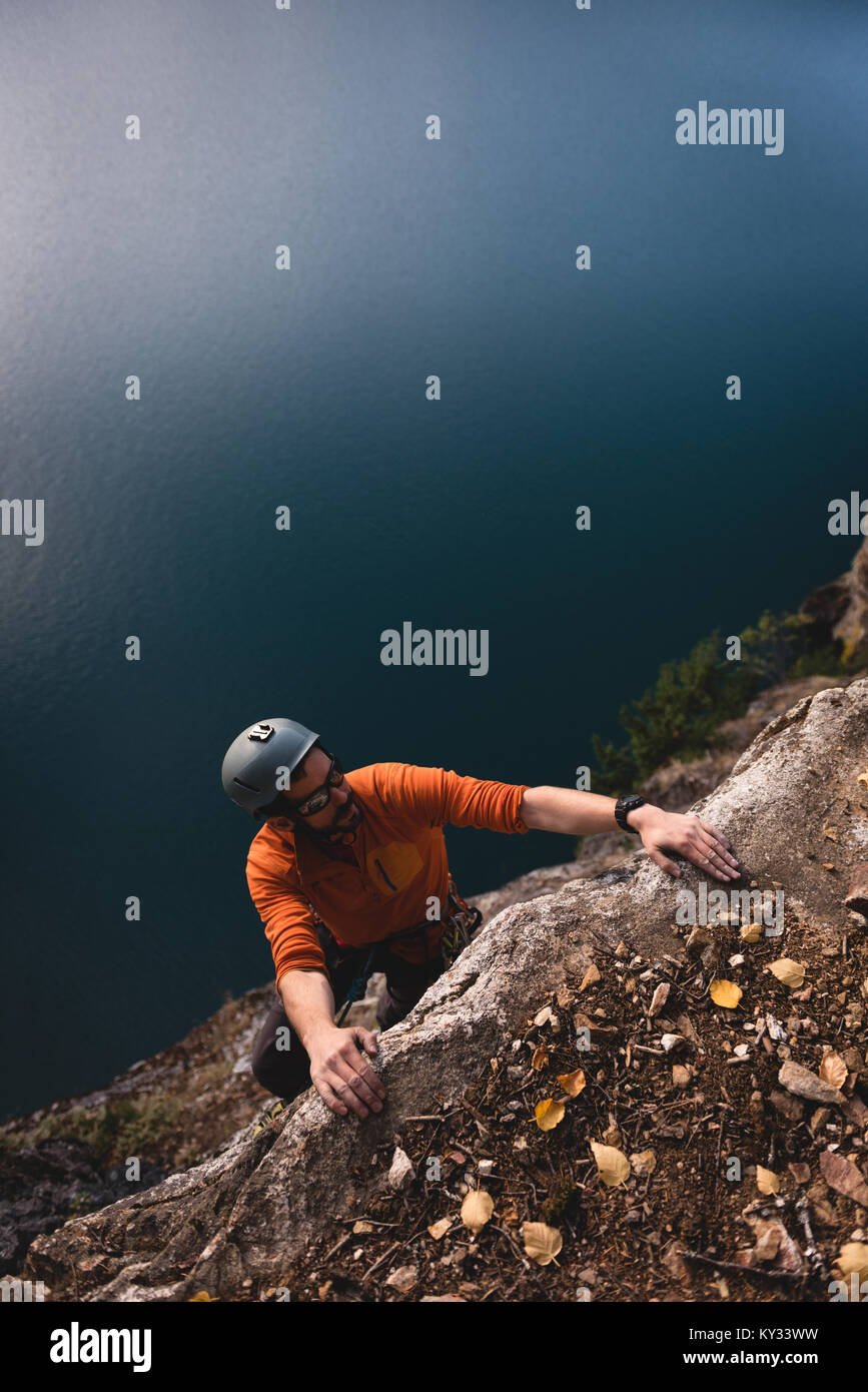 Rock climber reaching on the cliff top Stock Photo - Alamy