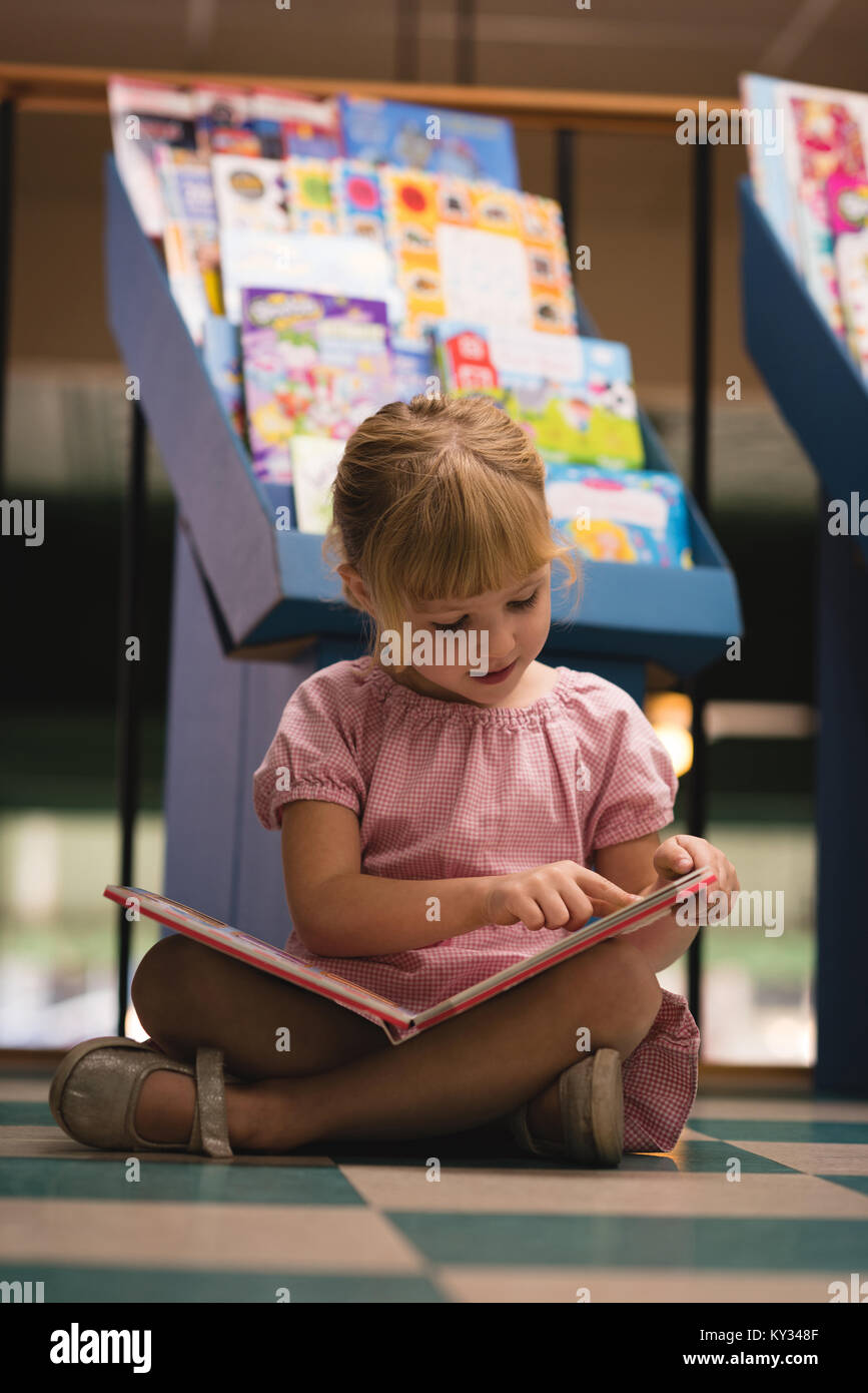 Cute girl reading book Stock Photo - Alamy
