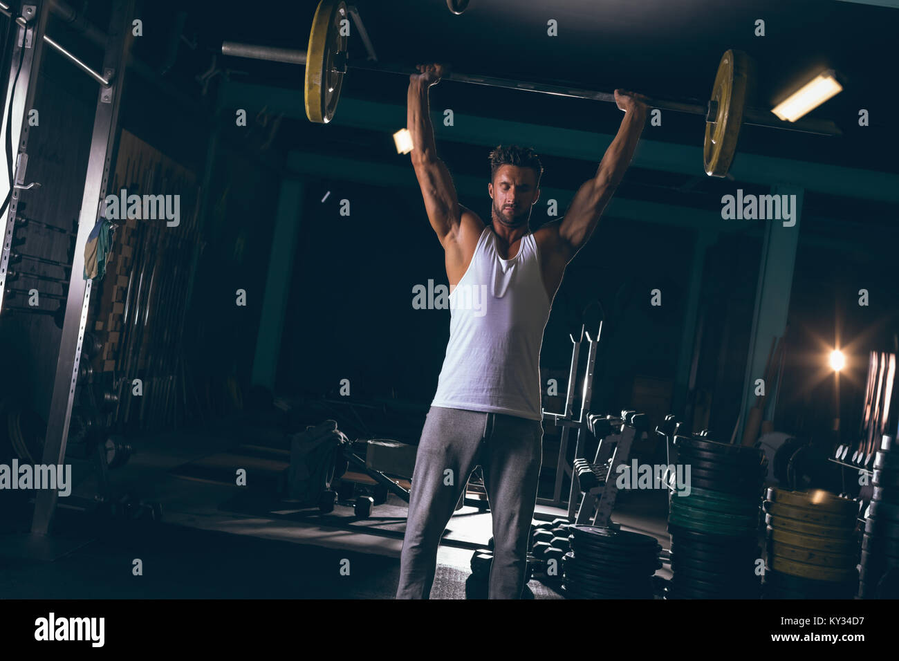 Portrait of muscular man exercising with barbell Stock Photo - Alamy