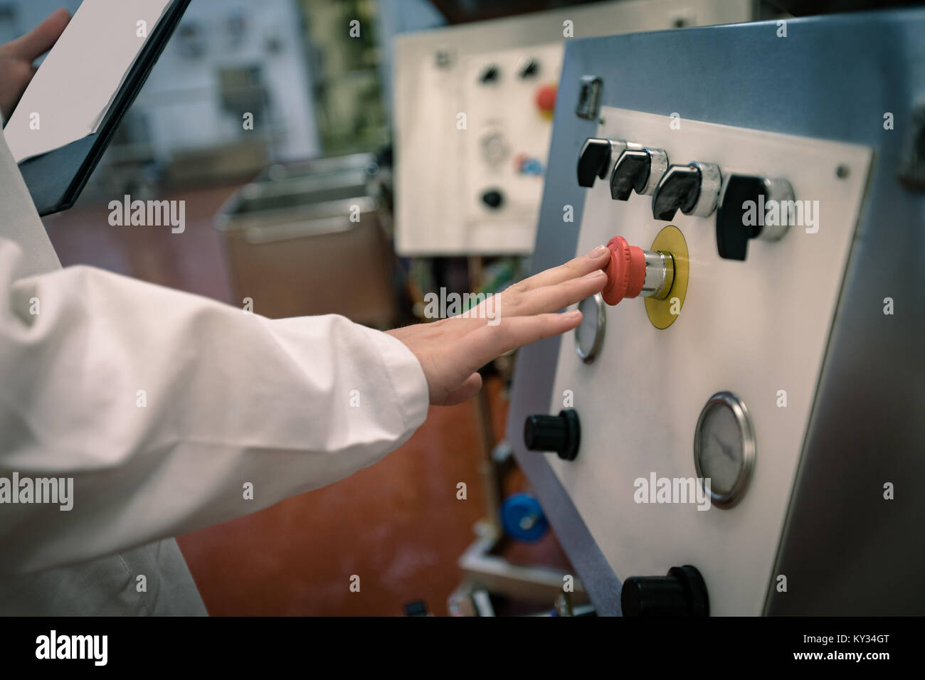 Worker pressing the control switch Stock Photo - Alamy