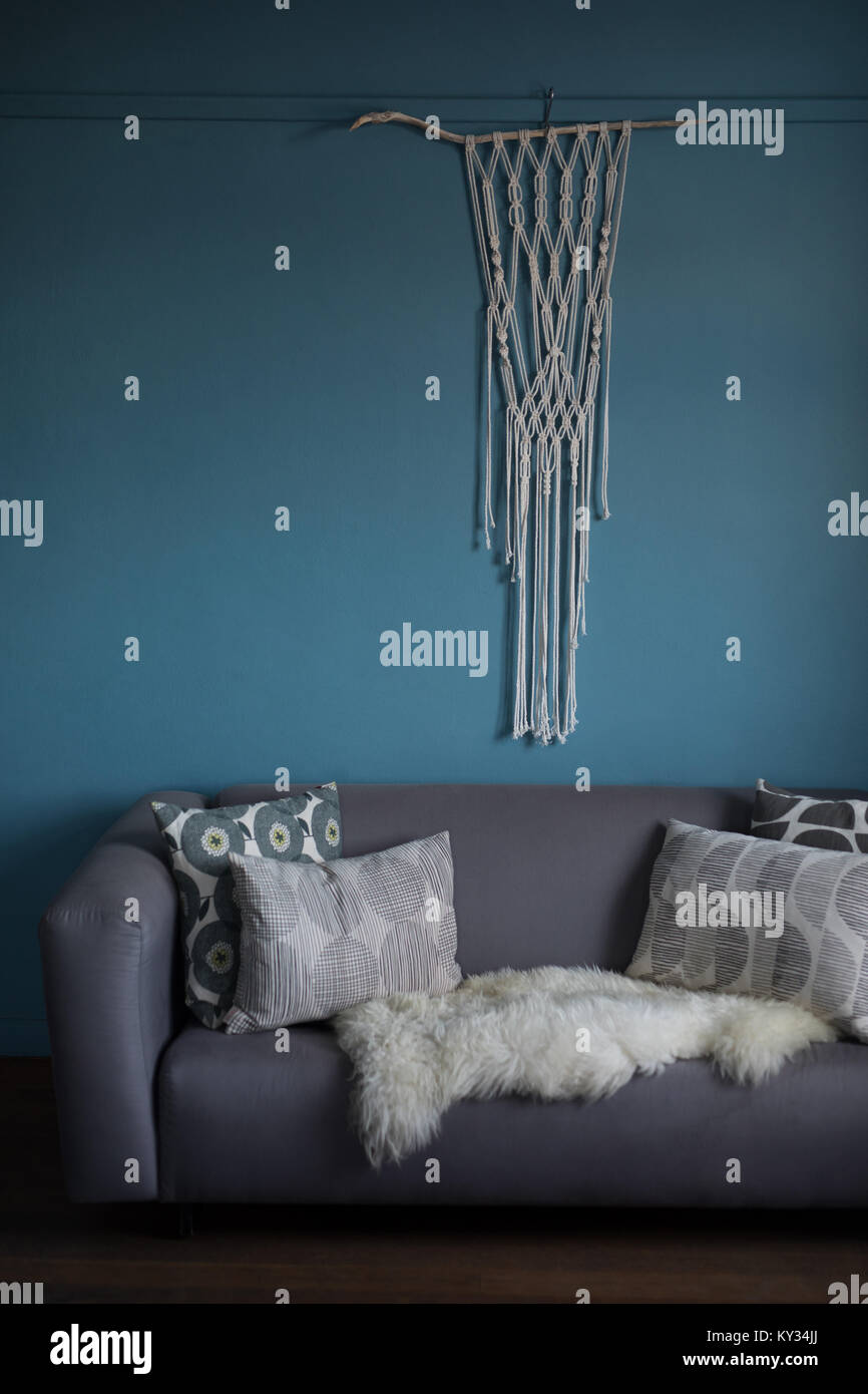 Thread curtain hanging against blue wall Stock Photo - Alamy