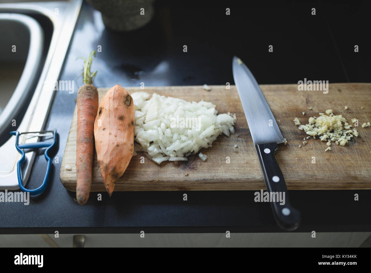 Chopped vegetables with knife on cutting board Stock Photo - Alamy