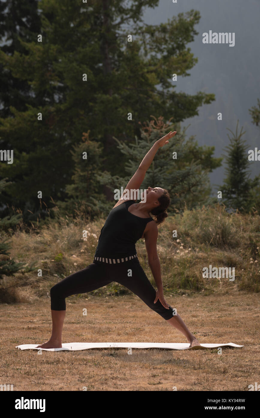 Fit woman performing stretching exercise on an open ground Stock Photo ...