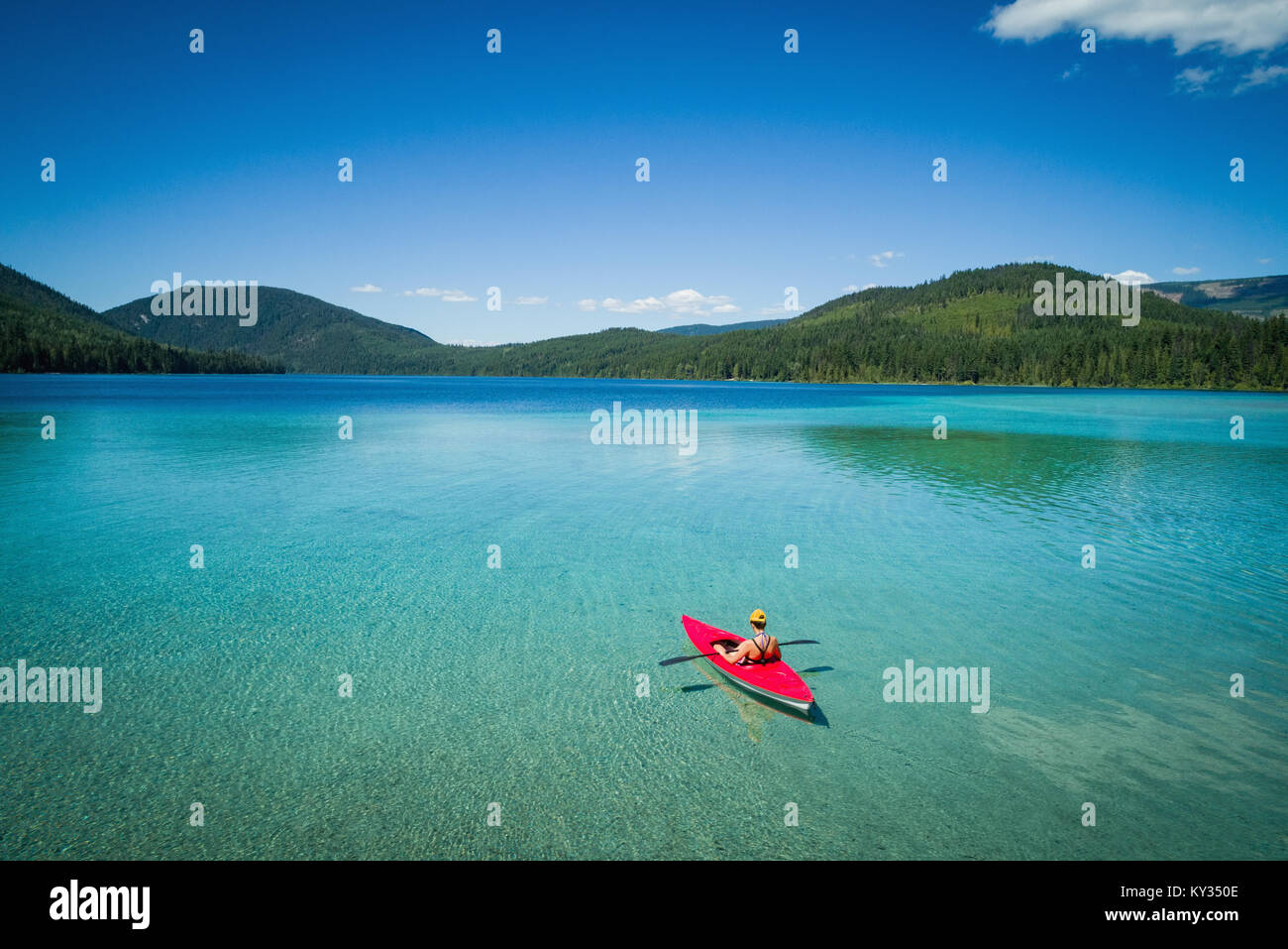 Kayaker kayaking in shallow turquoise water Stock Photo - Alamy