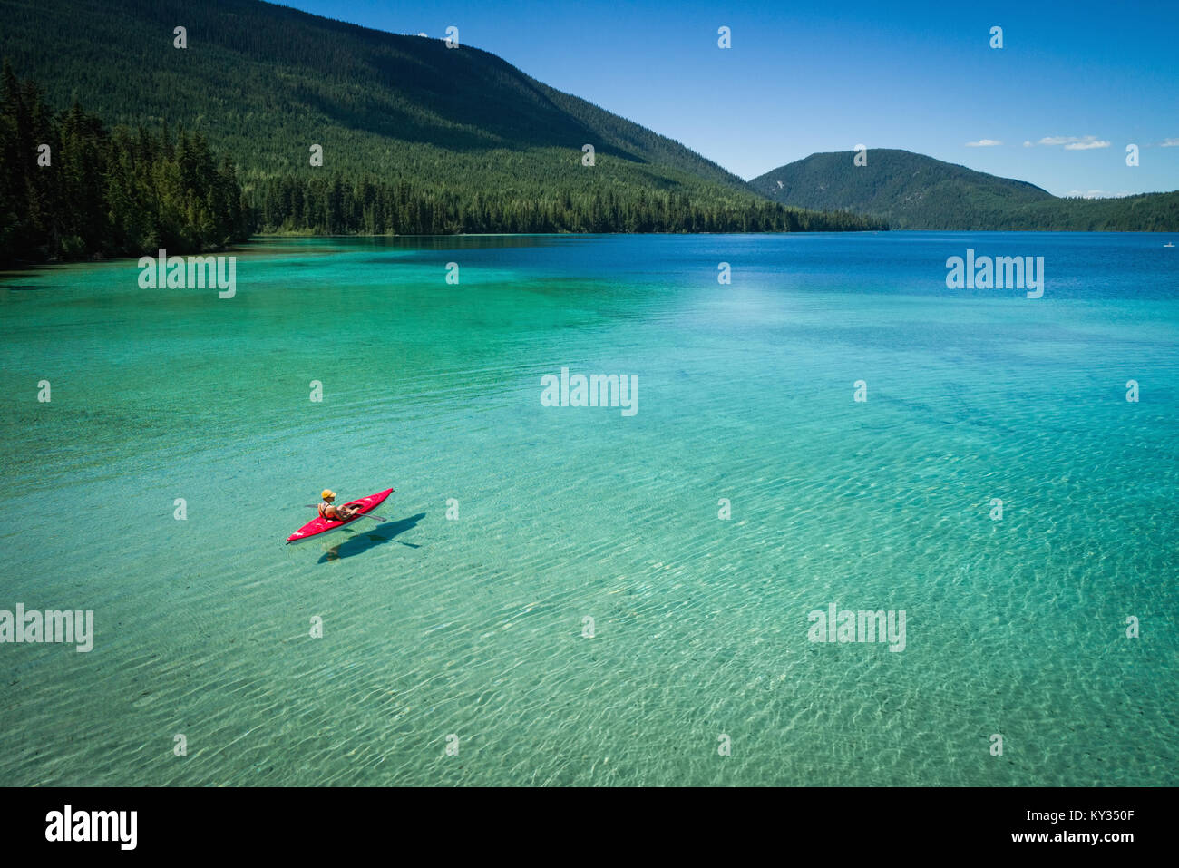 Kayaker kayaking in shallow turquoise water Stock Photo - Alamy