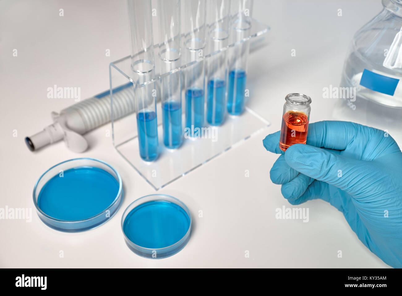 Scientific background in blue, white and orange. Liquid sample in ...