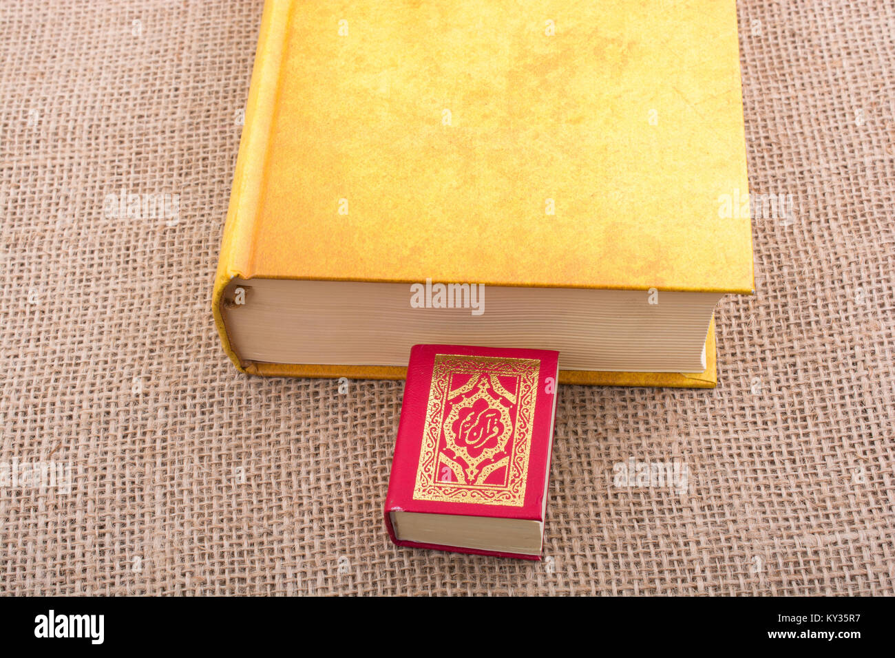Islamic Holy Book Quran in mini size with another book Stock Photo - Alamy