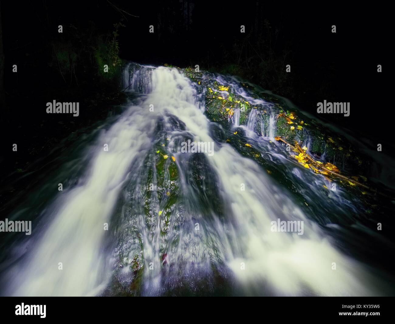 Night waterfall. White water spray in waterfall on stream, foamy water ...