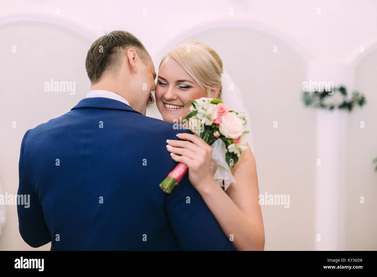 Bride and groom on marriage registration. The groom looks at the bride ...
