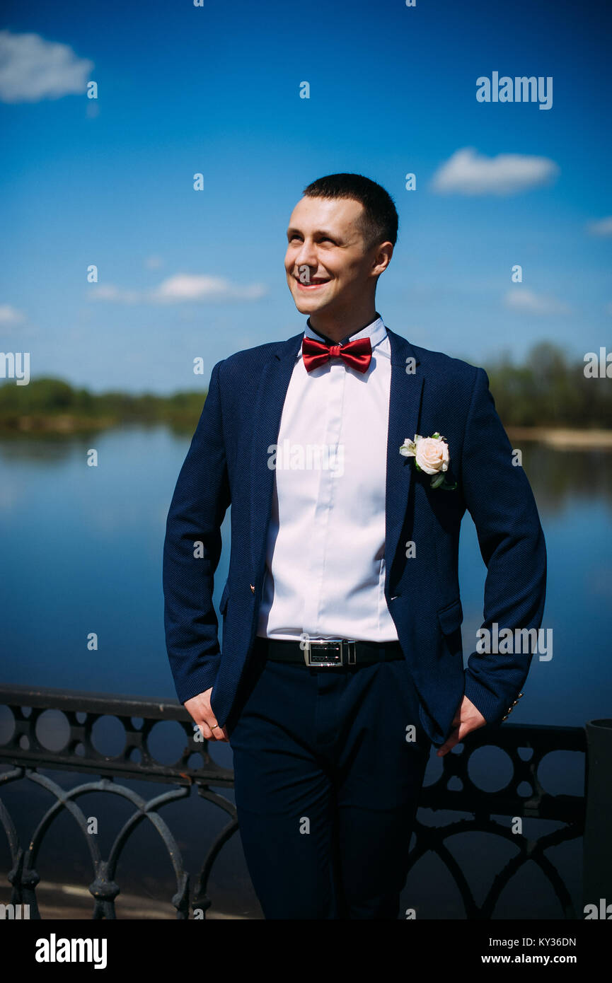 happy and beautiful groom and bride tender kiss at spring outdoors at ...