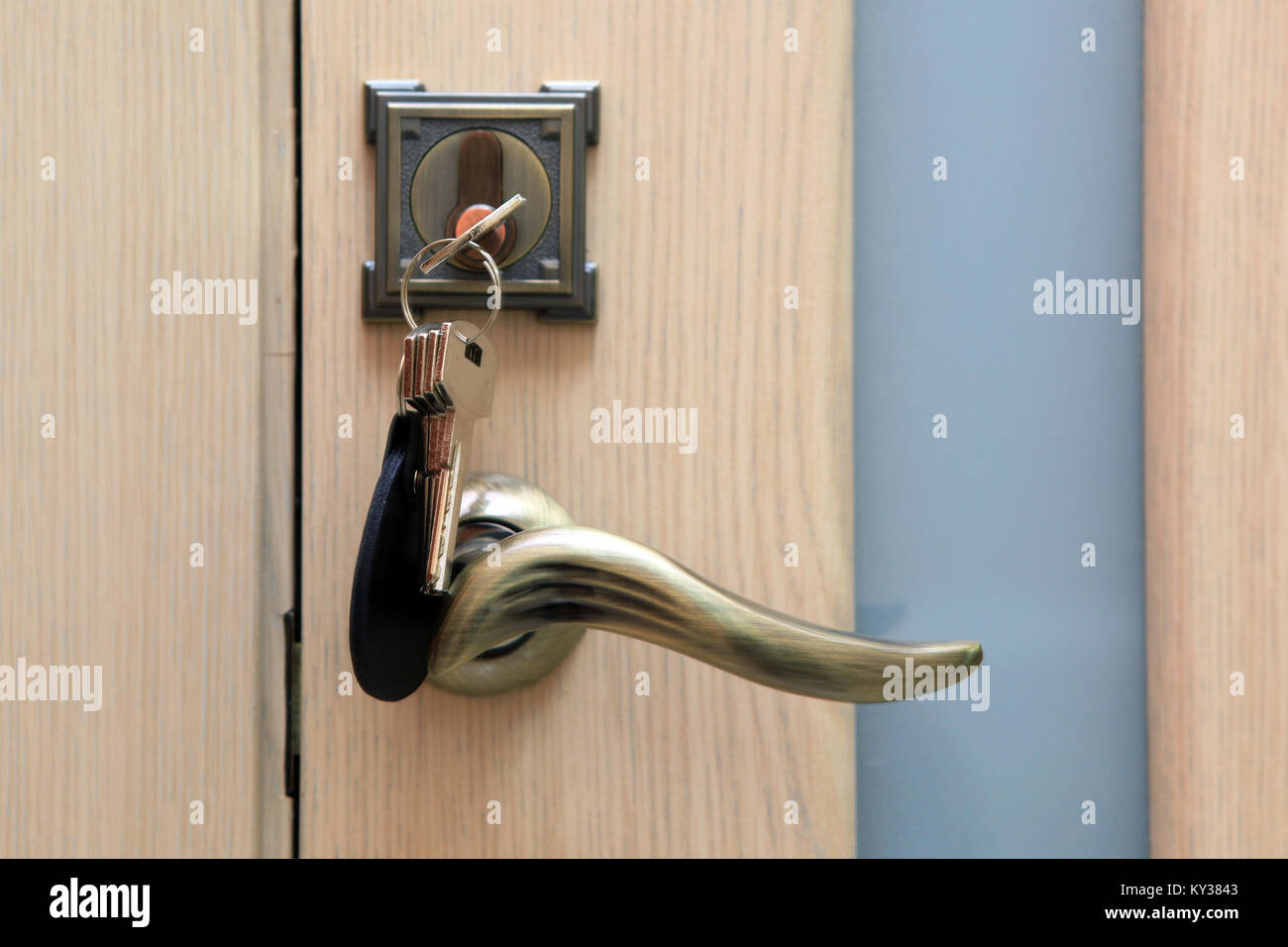 Keys left in a keyhole Stock Photo - Alamy