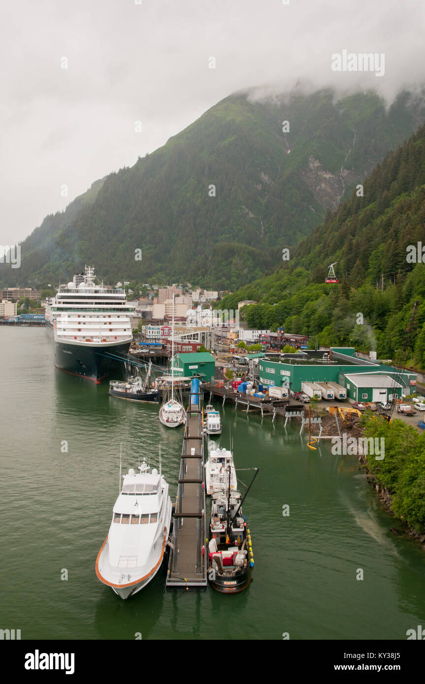 View of port of small Juneau town with boats and cruise ships anchored ...