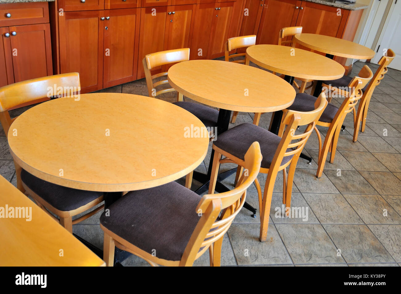Clean tables lined up neatly in dining area Stock Photo - Alamy