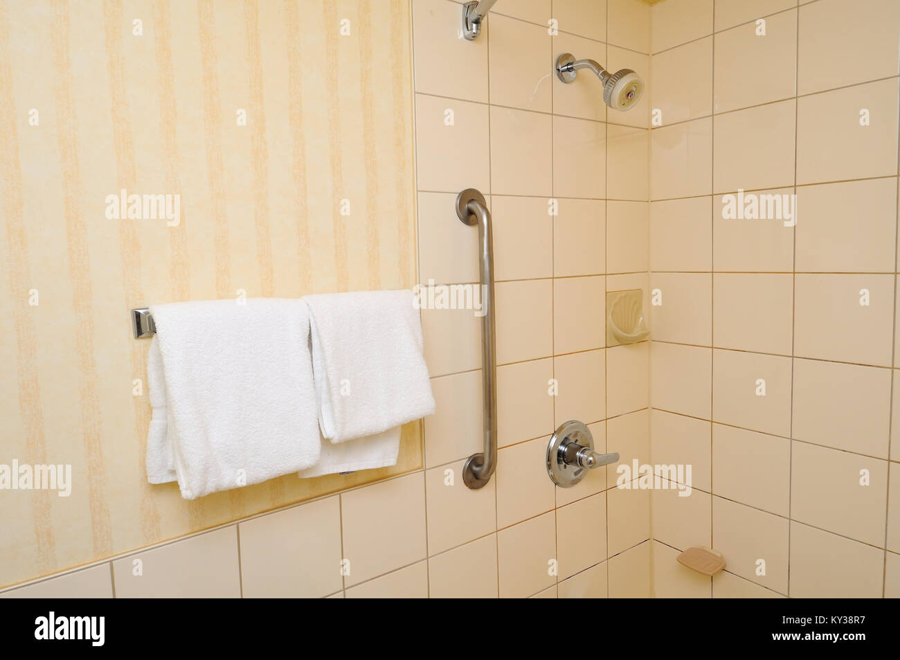 Clean white towels hanging beside shower point in bathroom Stock Photo ...