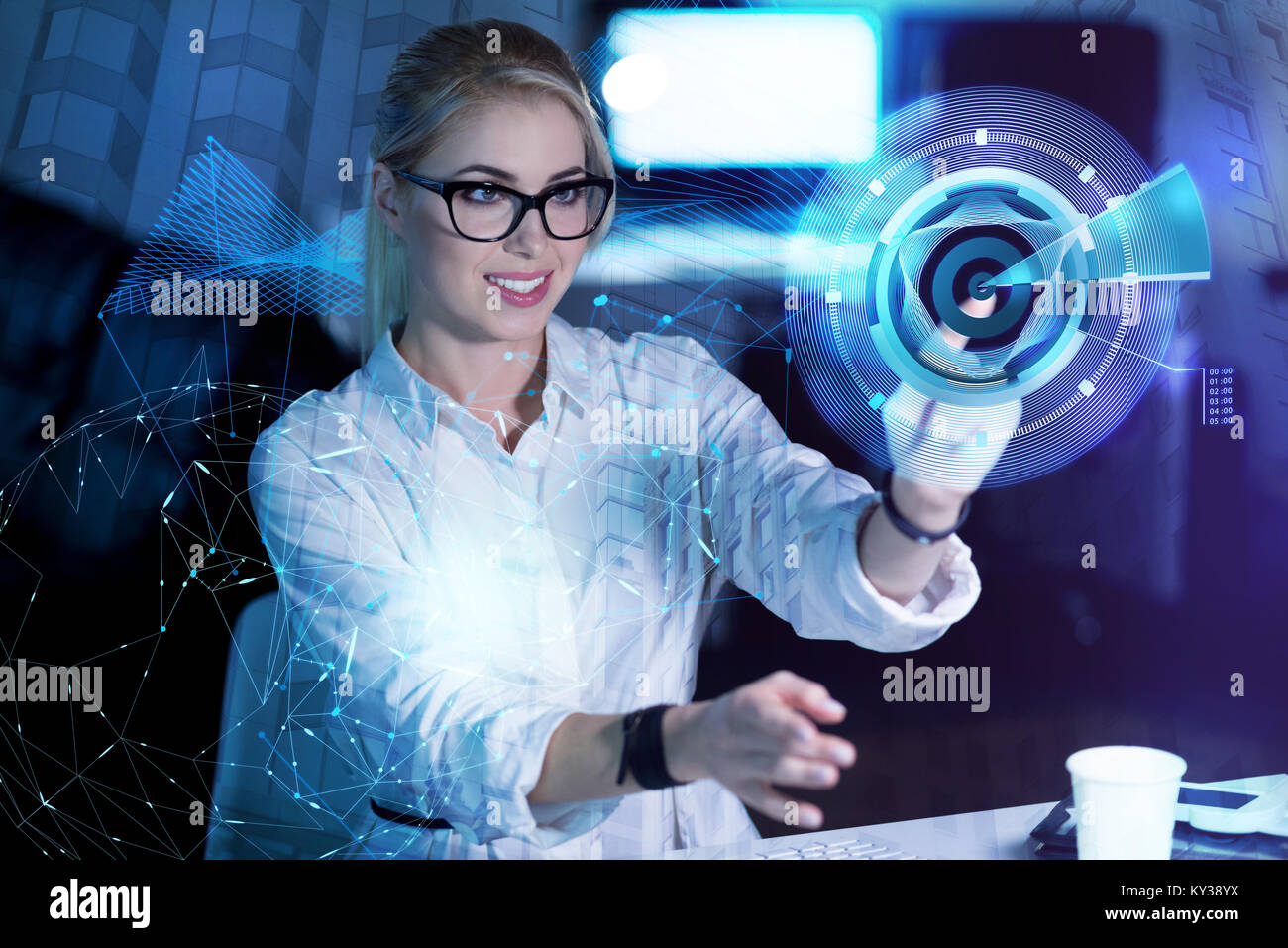 Smiling programmer touching the modern transparent screen while working Stock Photo - Alamy