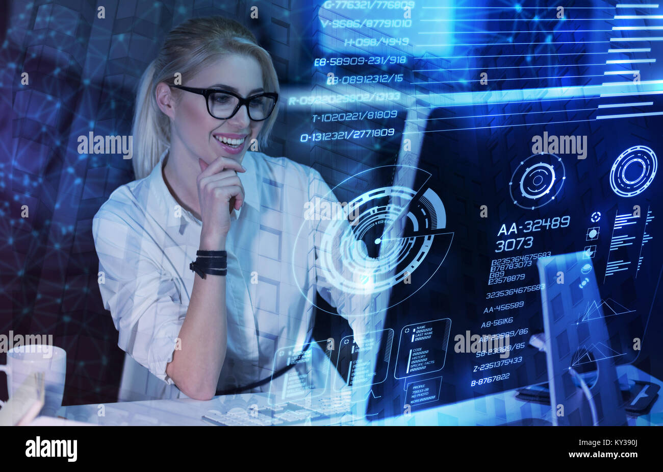 Happy programmer looking at the transparent screen of a computer and ...