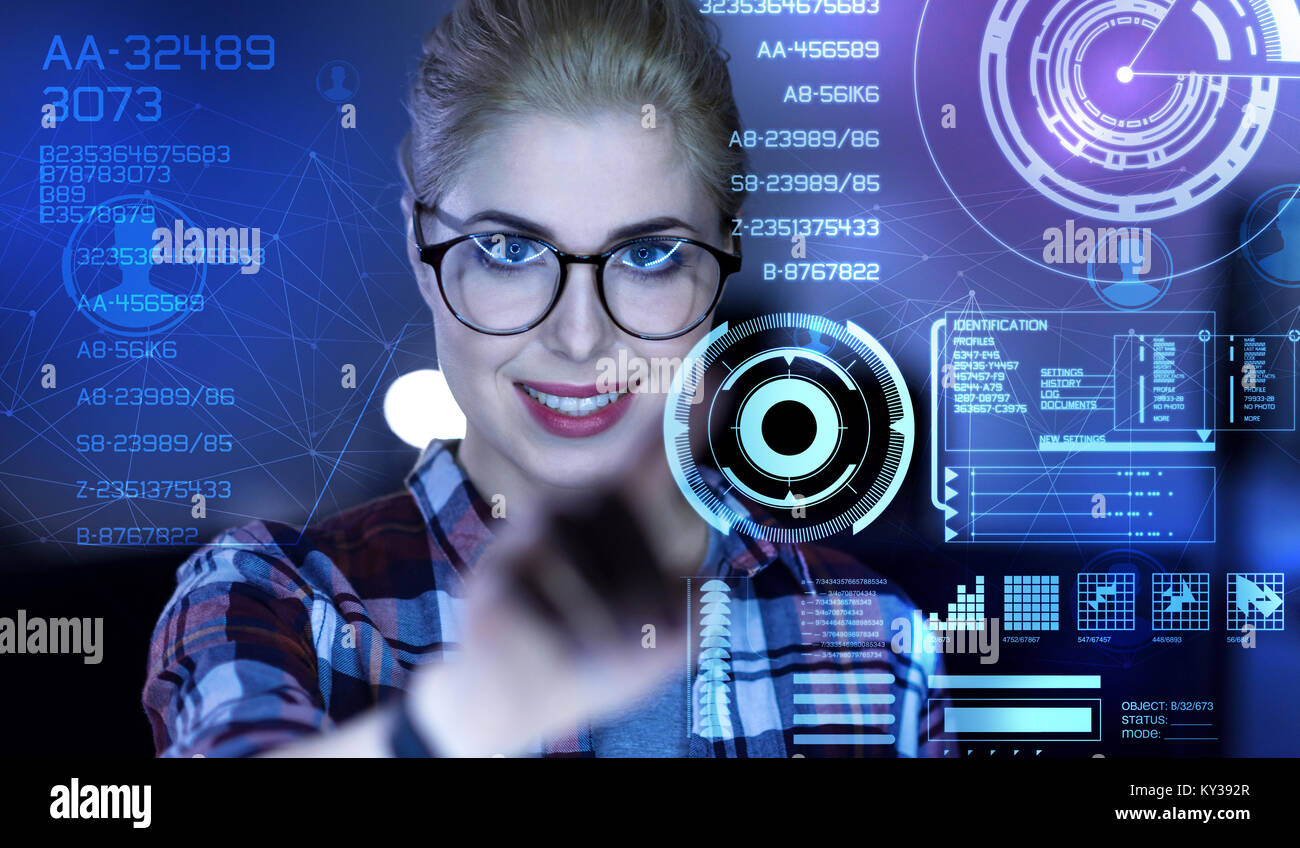 Smart beautiful programmer touching the transparent screen and smiling ... Smart beautiful programmer touching the transparent screen and smiling ...