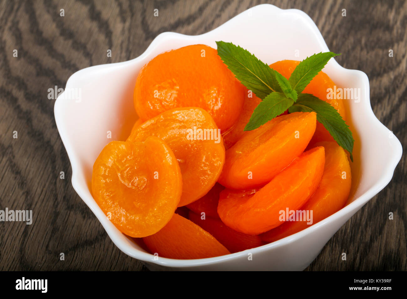 Canned apricots with mint leaves Stock Photo - Alamy