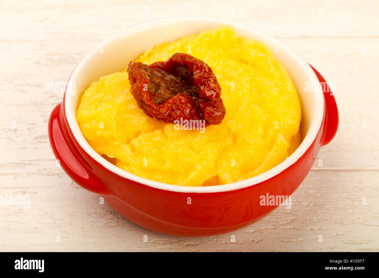 Polenta with dry tomato Stock Photo - Alamy