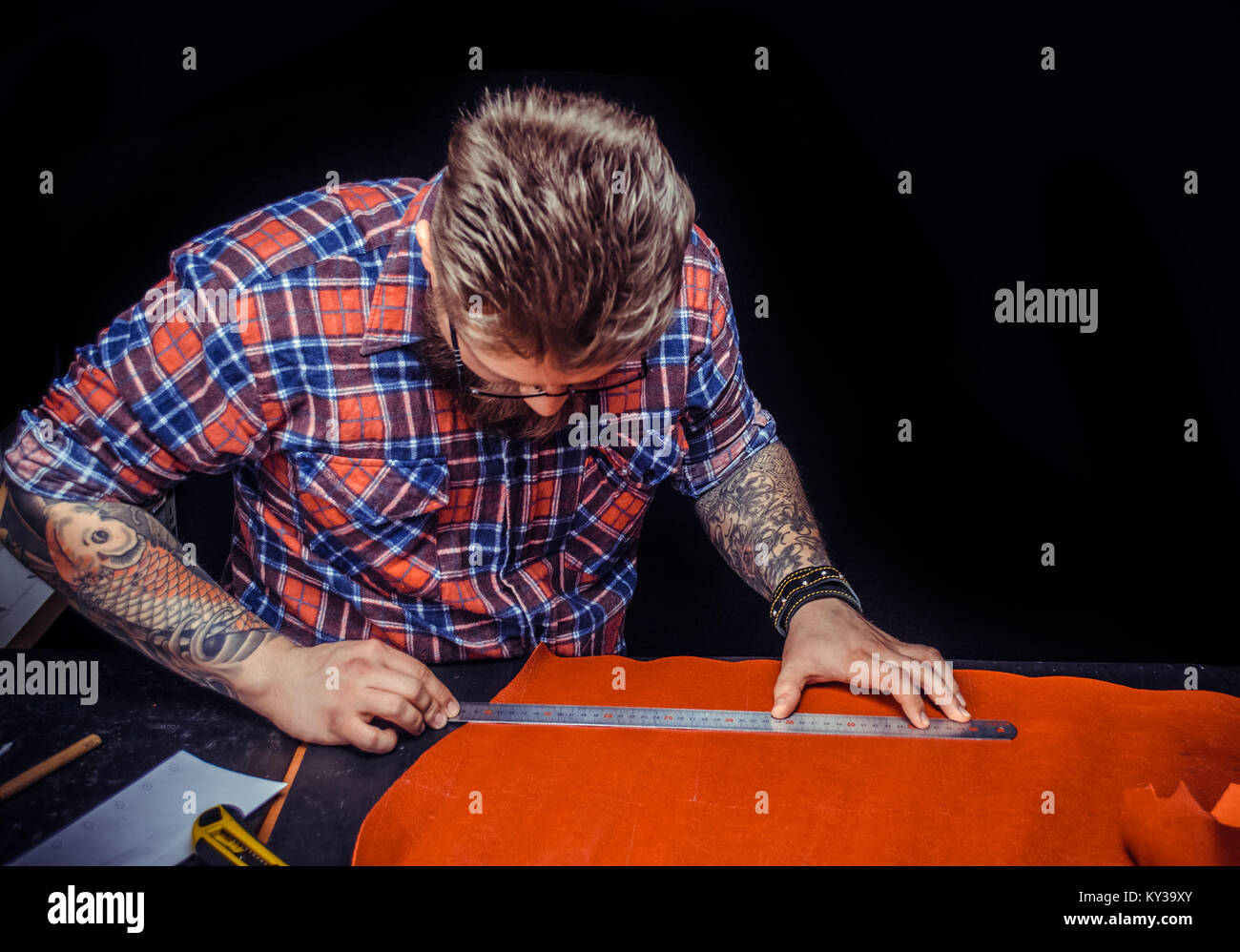 Currier of leather working with leather in the tanner shop Stock Photo ...