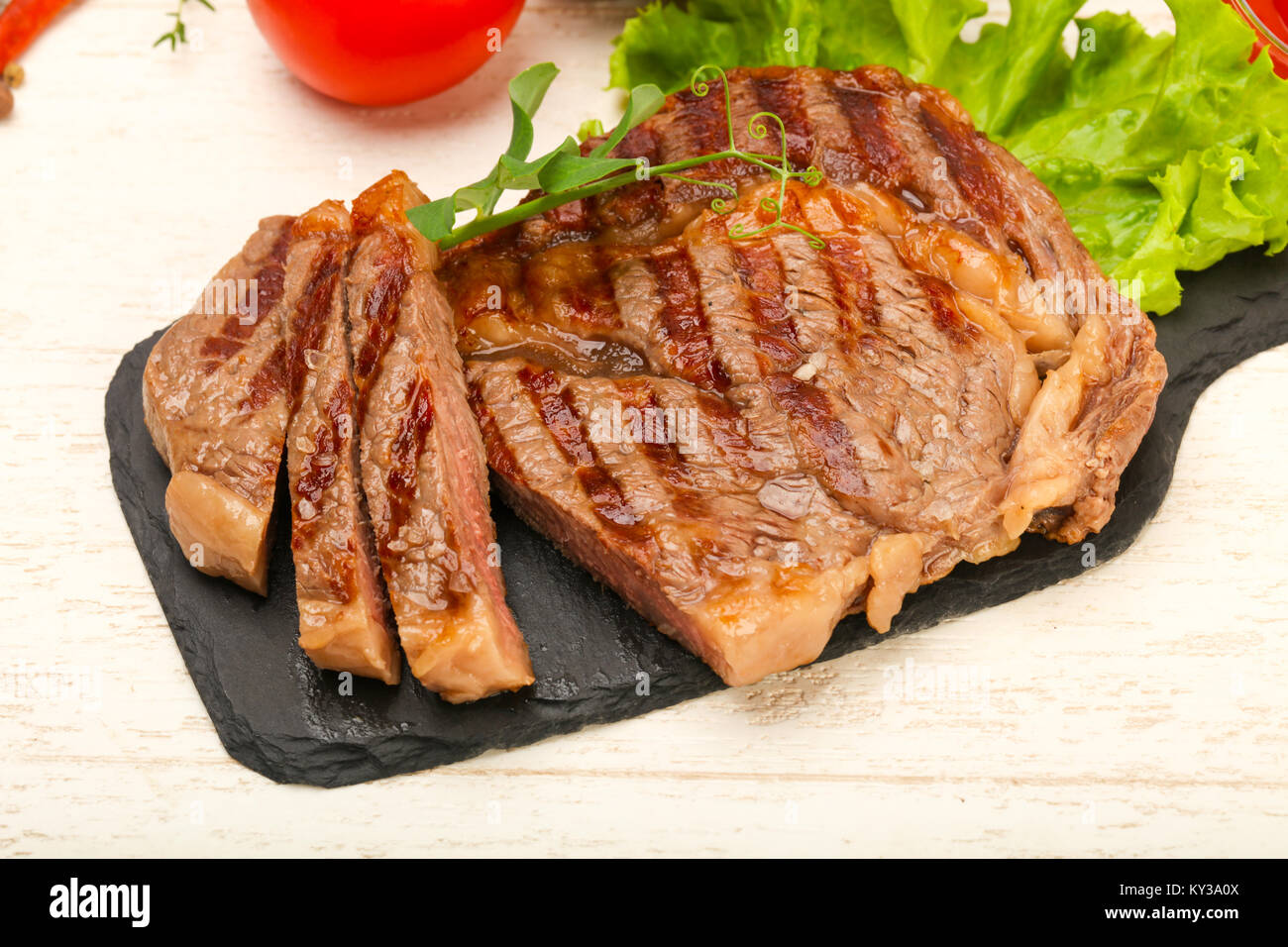 Grilled Rib eye steak with sauce Stock Photo - Alamy