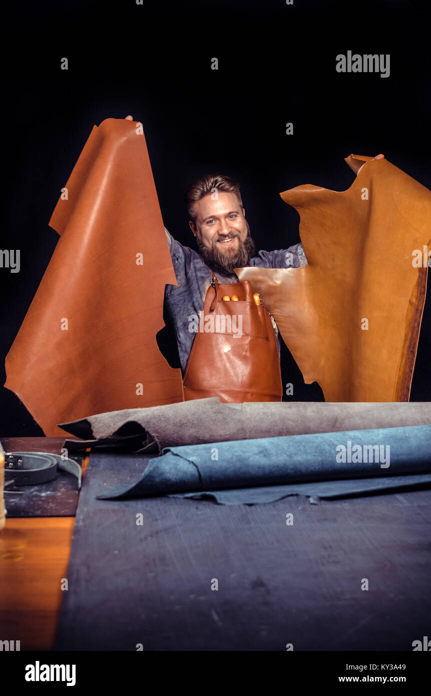 Currier of leather works with leatherwork at a workshop Stock Photo - Alamy