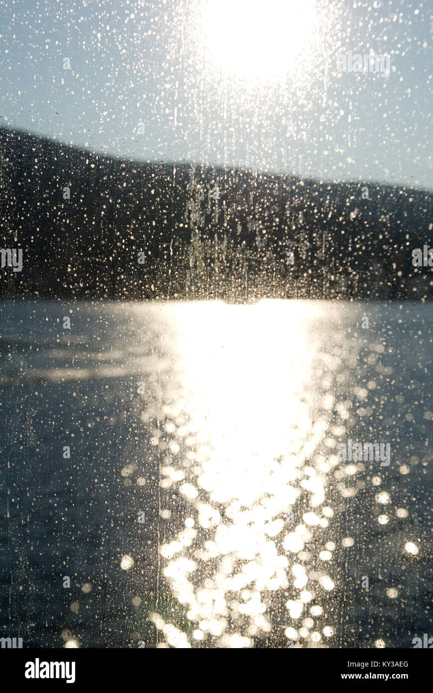 a view through a window covered with water droplets and condensation on ...