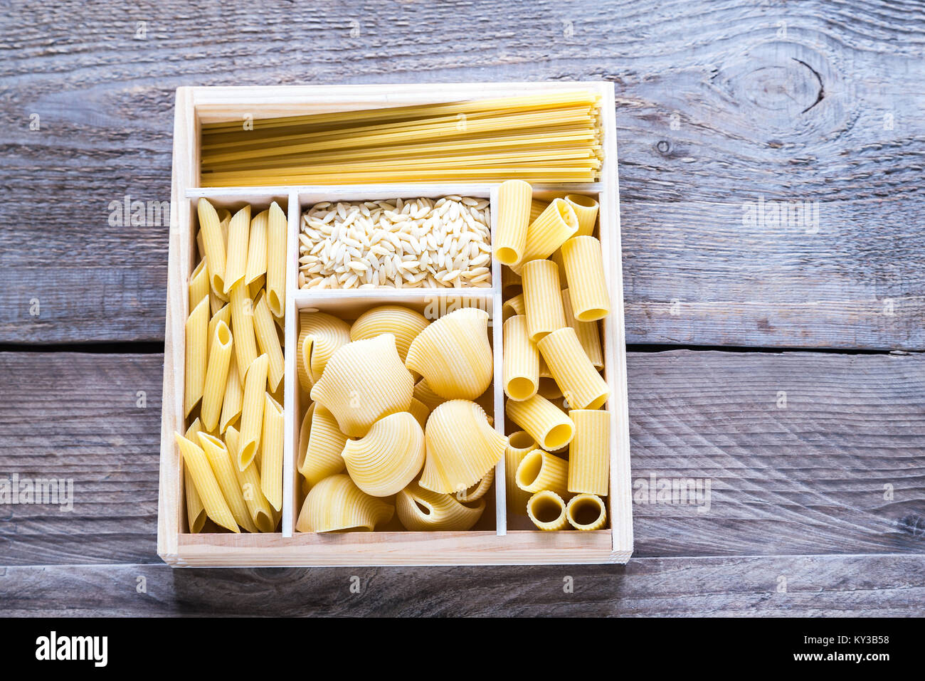 Various types of pasta in the wooden container Stock Photo - Alamy