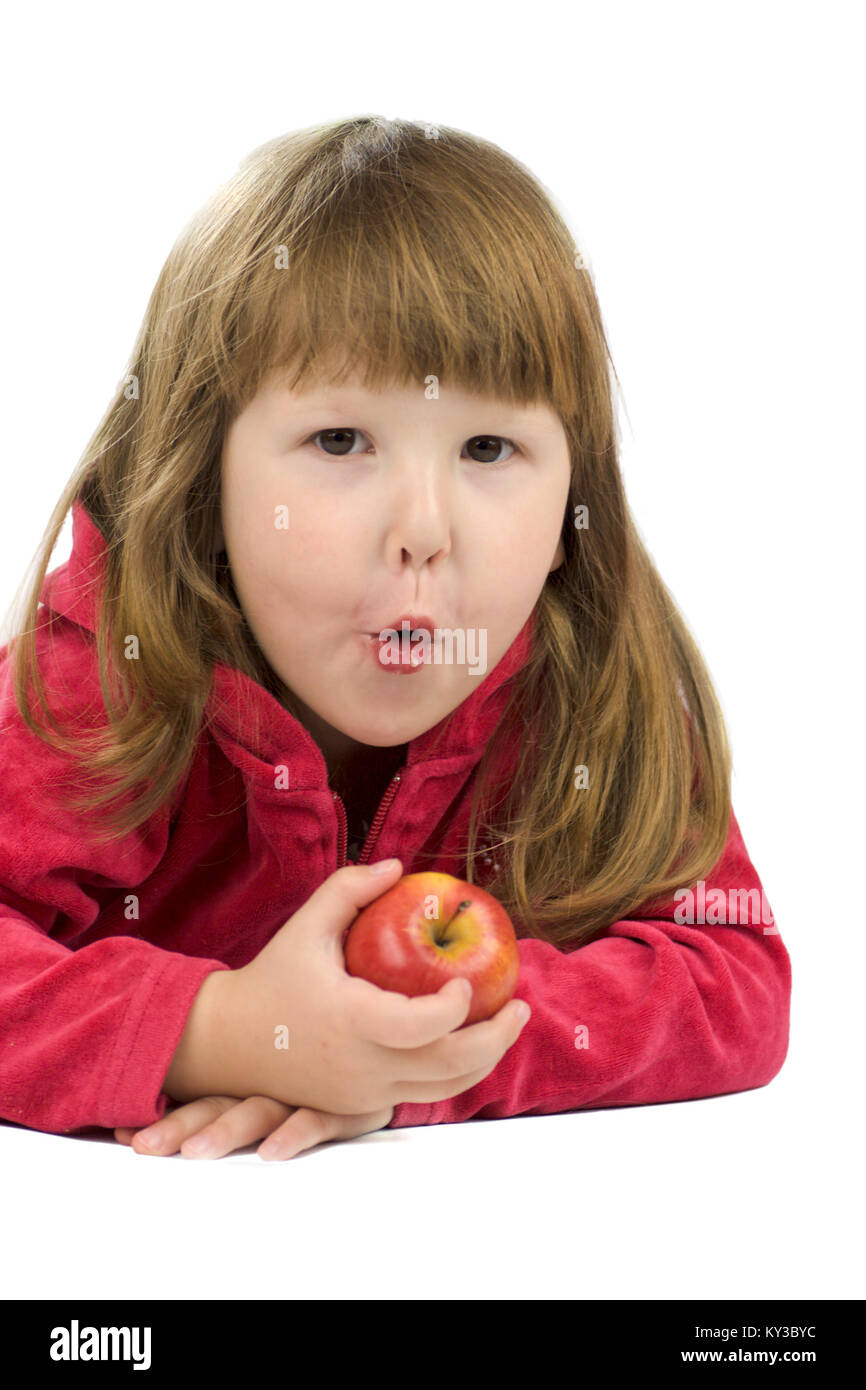 Cheerful kid holding apple with funny face isolated on white Stock ...