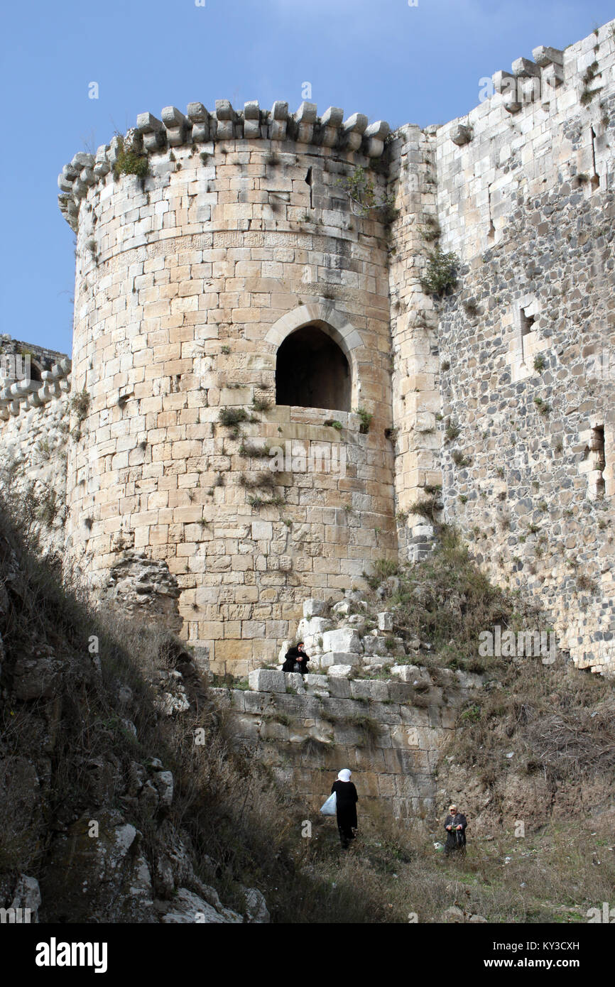 Tower of castle and muslim women in Syria Stock Photo - Alamy