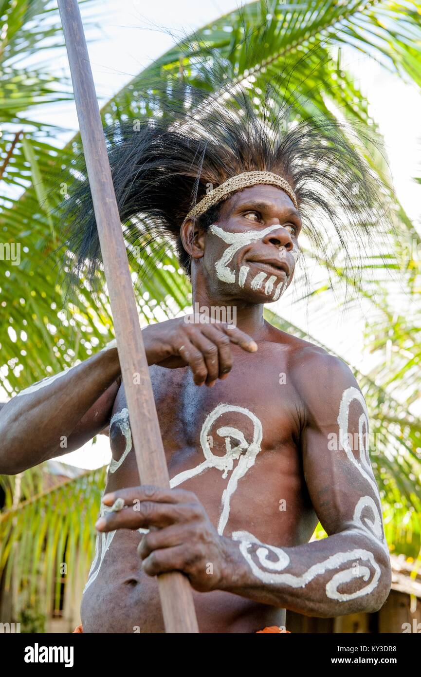 Headhunter of Asmat tribe with a traditional painting on a face ...