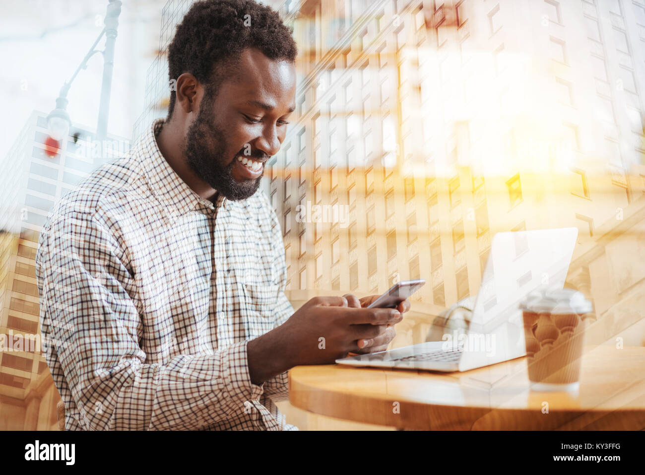 Handsome Afro-American typing message Stock Photo - Alamy