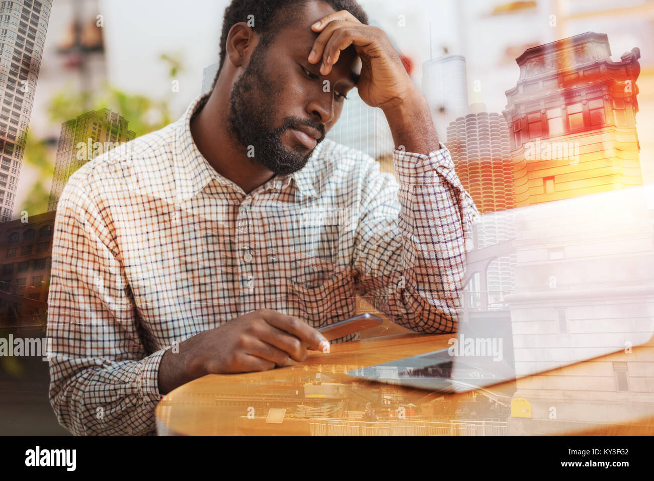 Upset international man looking downwards Stock Photo - Alamy