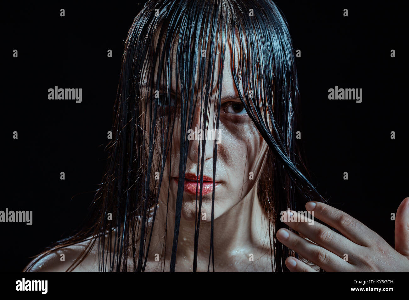 serious angry woman with wet black hair looking at camera Stock Photo ...