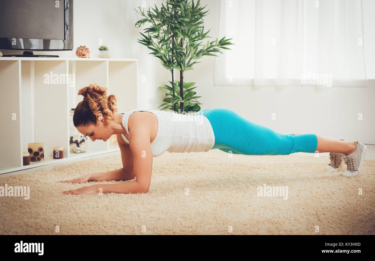 Beautiful muscular girl doing plank exercise at the flat Stock Photo ...