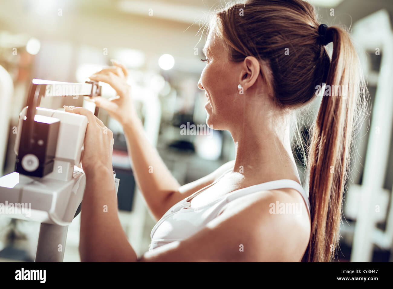 Young woman measuring weight before workout at the gym Stock Photo - Alamy