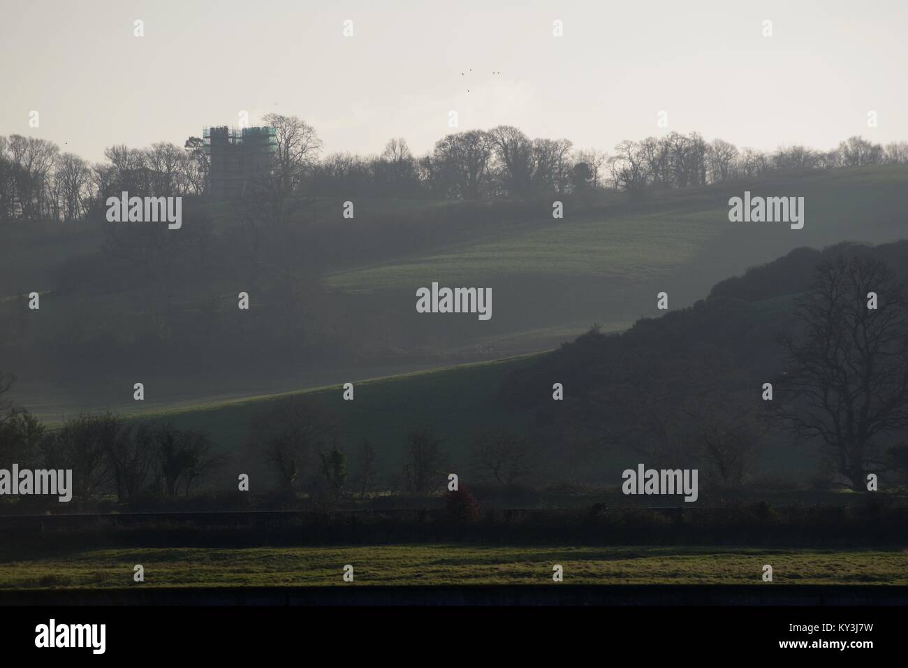 Layered Hazy Landscape of the Wooded Farmland of Powderham Estate with ...