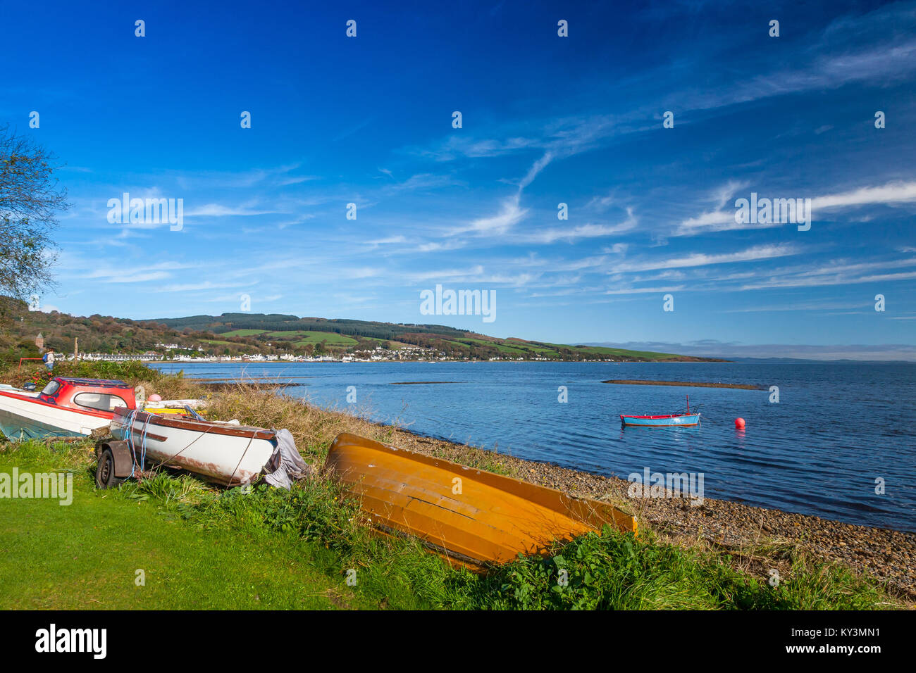 Small fishing boats sitting on a beach at Lamlash Bay, Isle of Arran ...