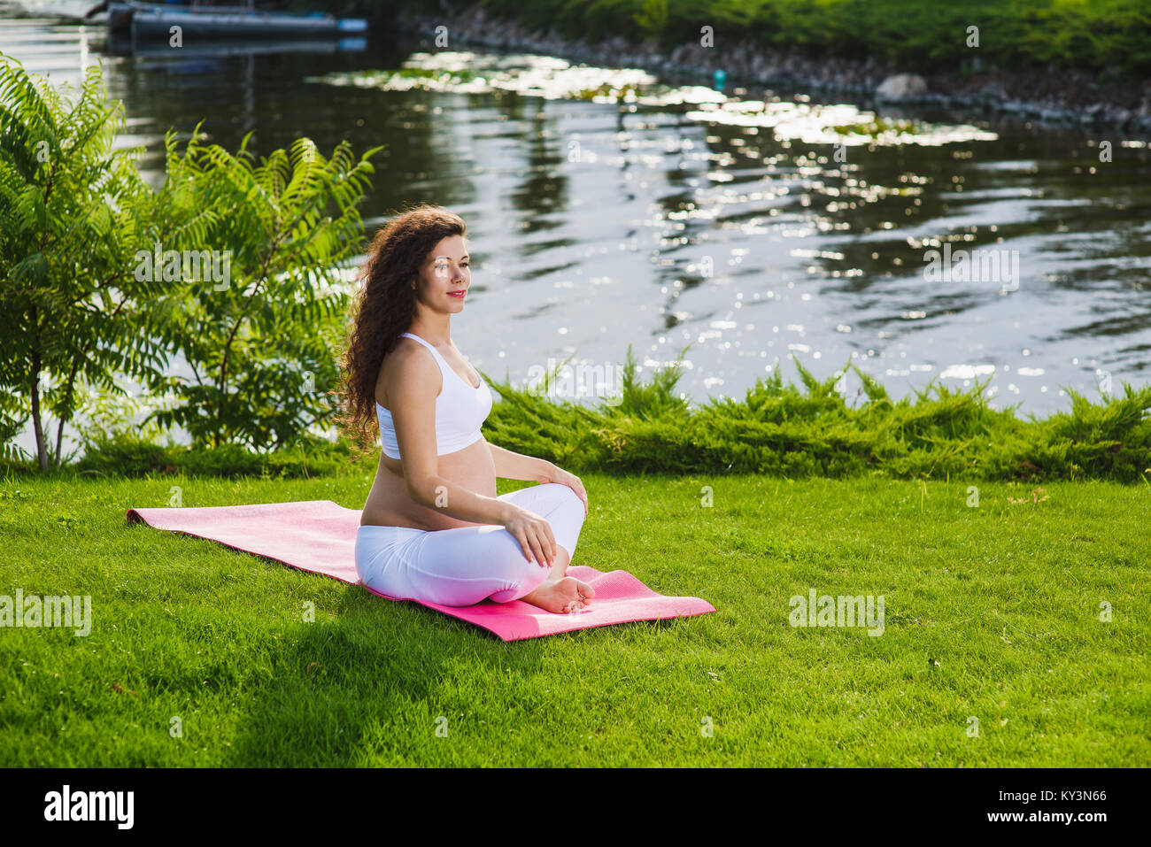 Pregnant Woman Meditating While Sitting In Lotus Position Sport