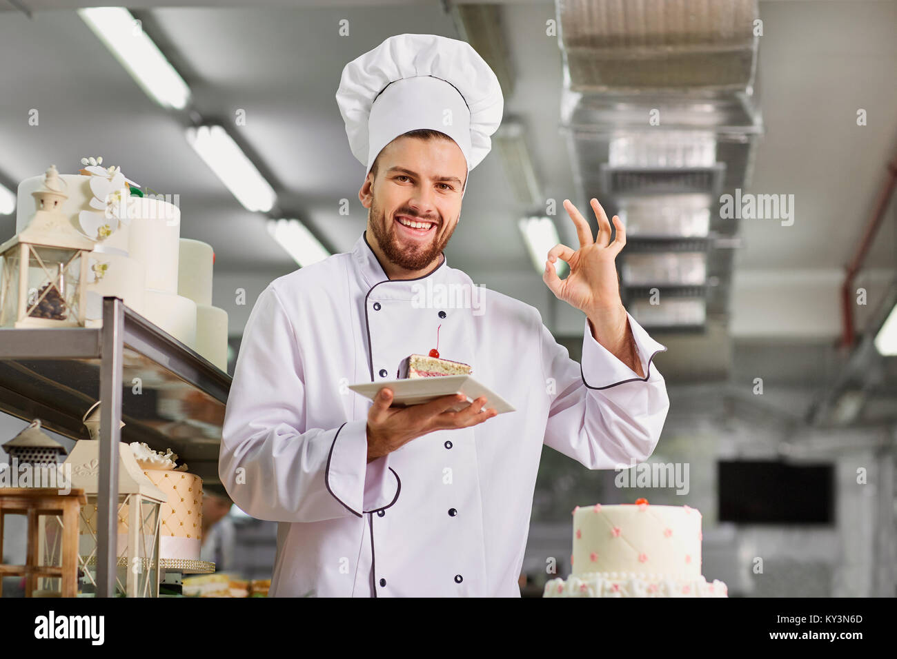 Man confectioner with a cake in his hands in the pastry Stock Photo - Alamy