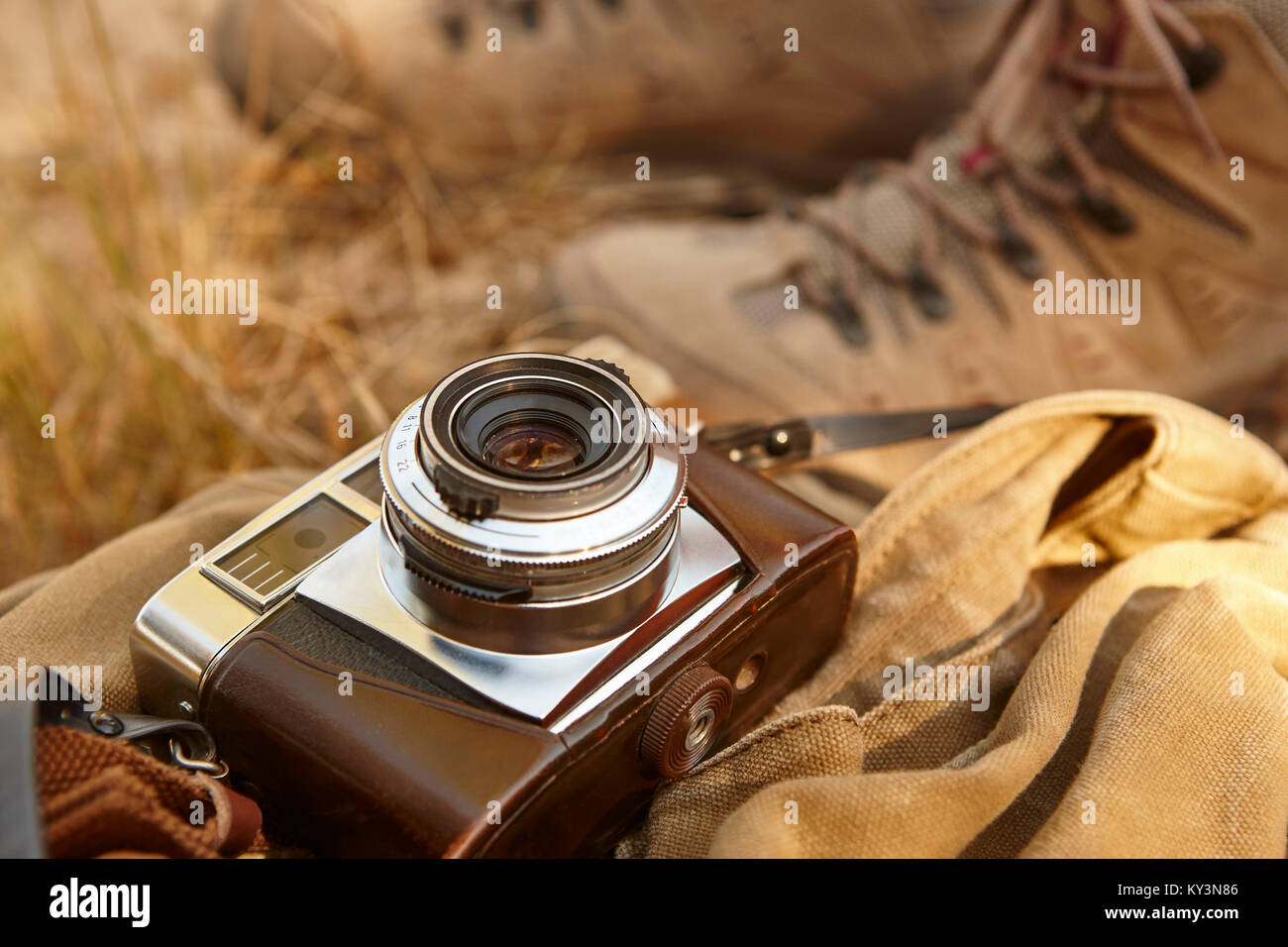 Vintage camera with hiking boots on the ground. Travel background Stock ...