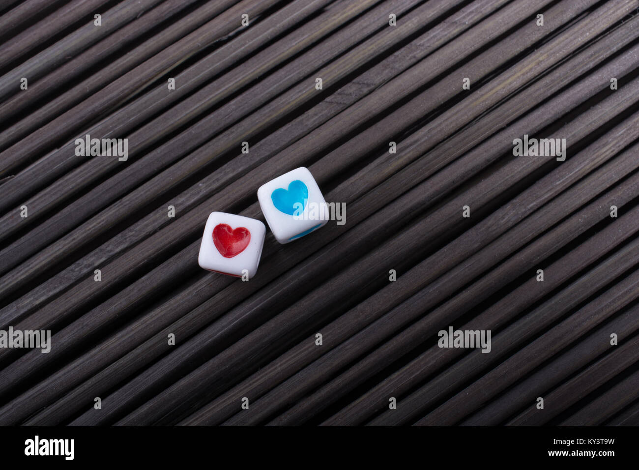 Colorful heart shaped love cubes on a straw mat Stock Photo - Alamy